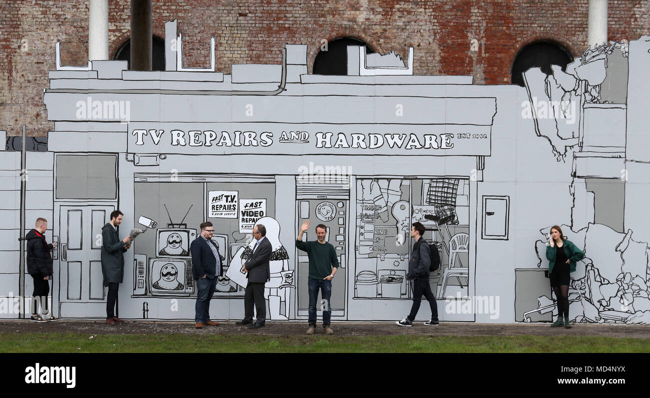 Artist Mick Peter(C) alongside members of the public as they stand ...