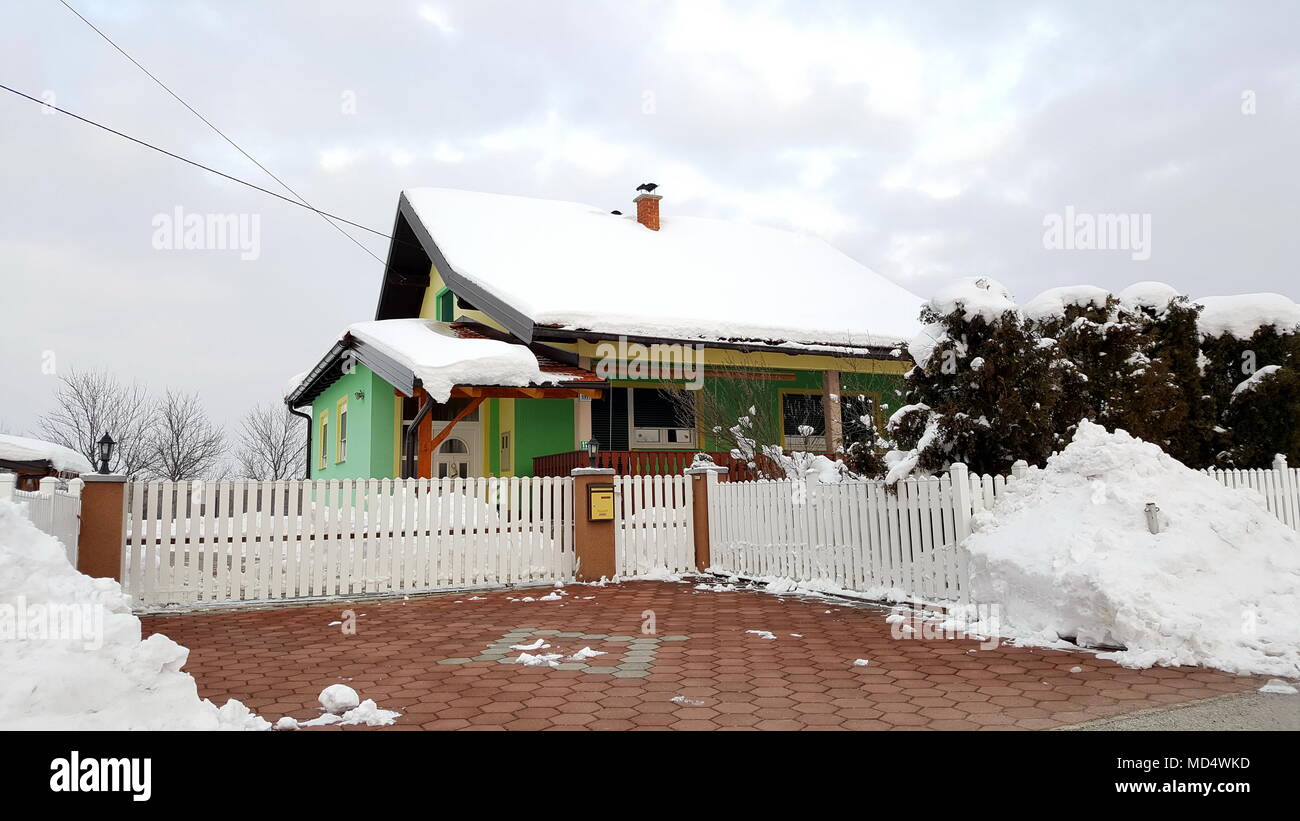 Colorful suburban house with large courtyard, white picket fence ...