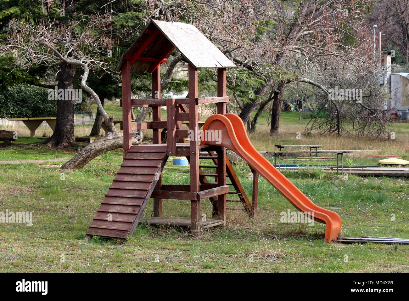 Outdoor wooden public playground equipment with climbing steps and ...