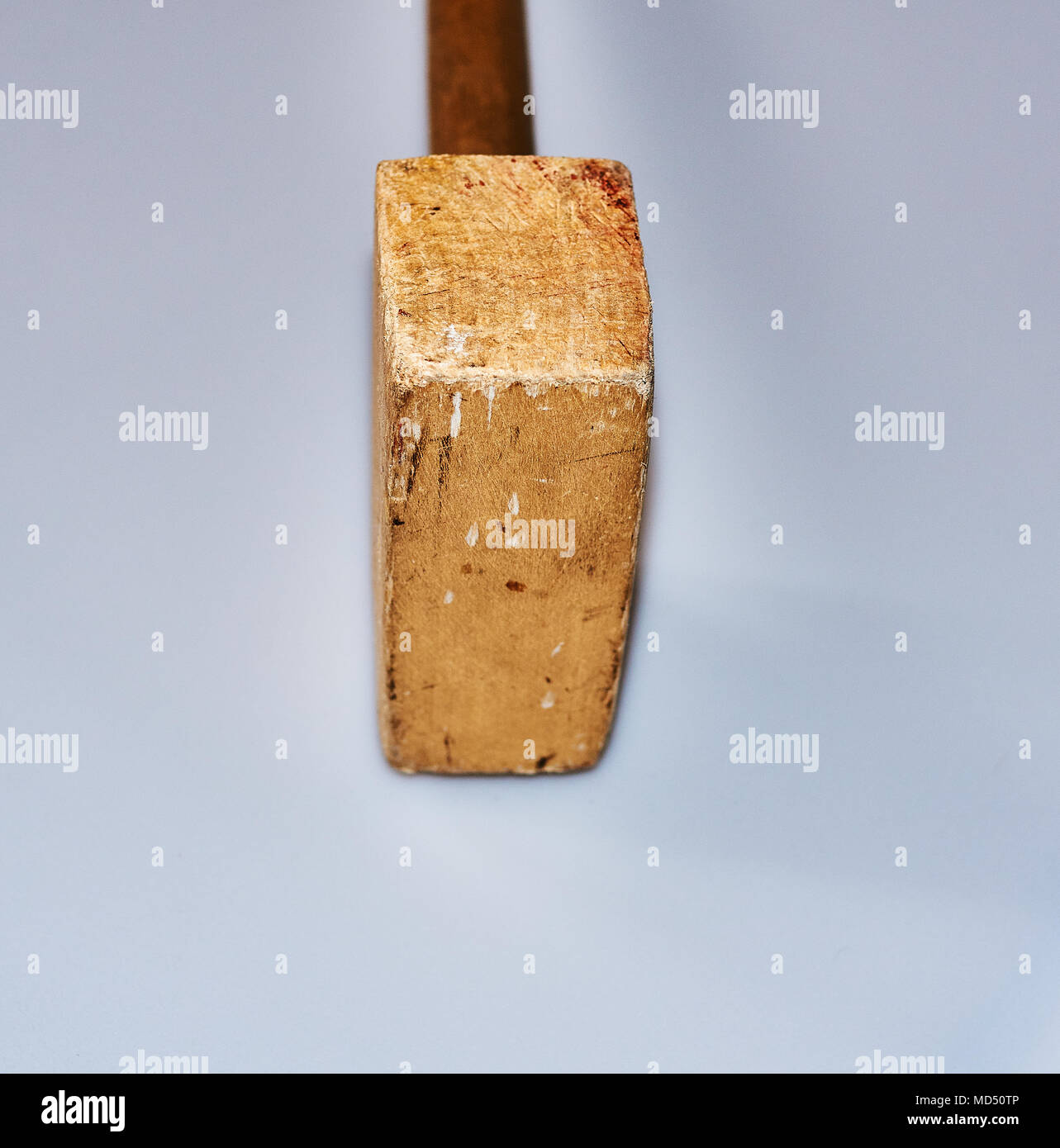 A hammer from a tree lies on an isolated background. The hammer was ...