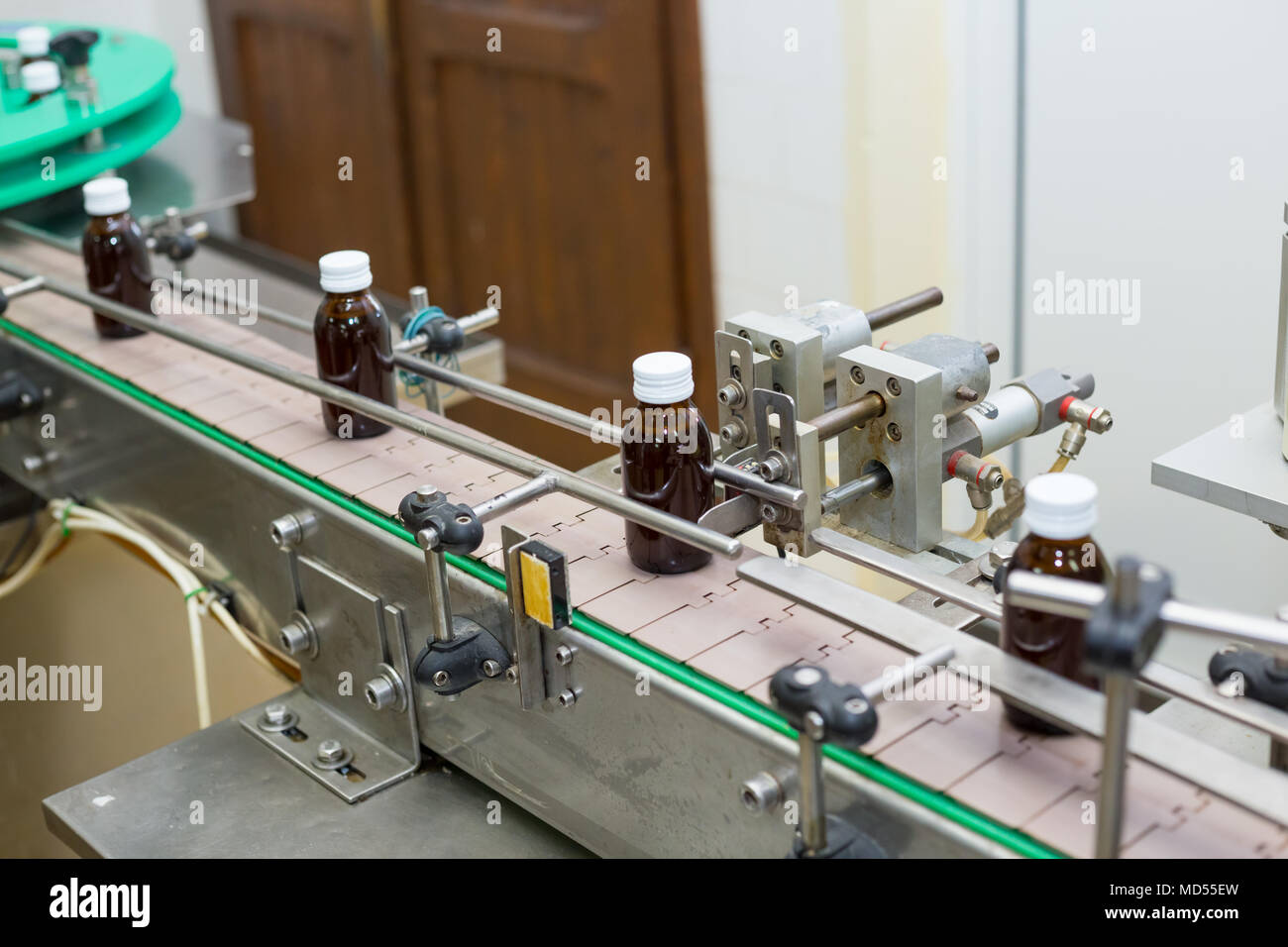 Pharmaceutical brown glass bottle production line Stock Photo - Alamy