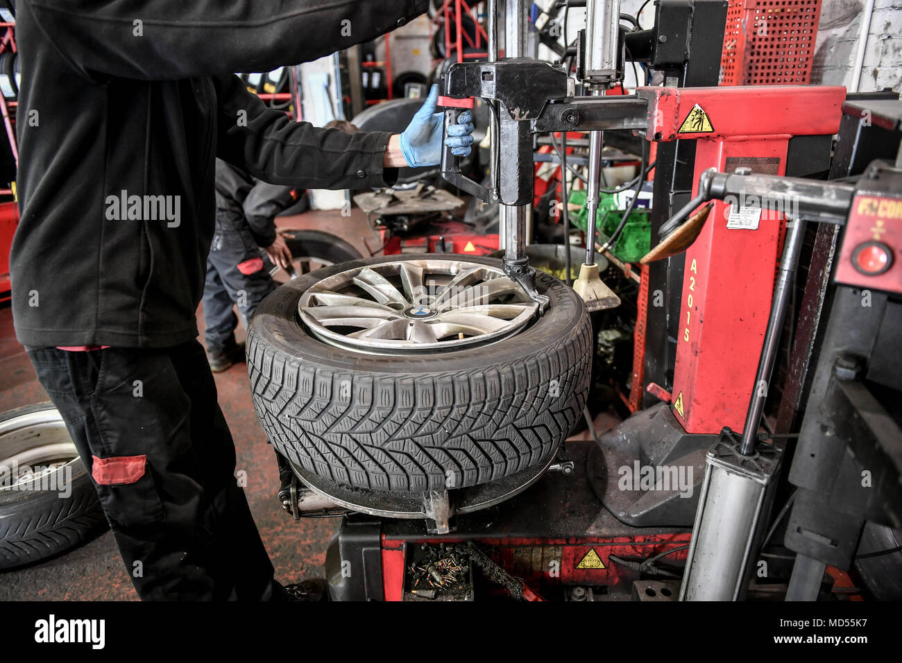 A mechanic works on a car tyre Stock Photo - Alamy