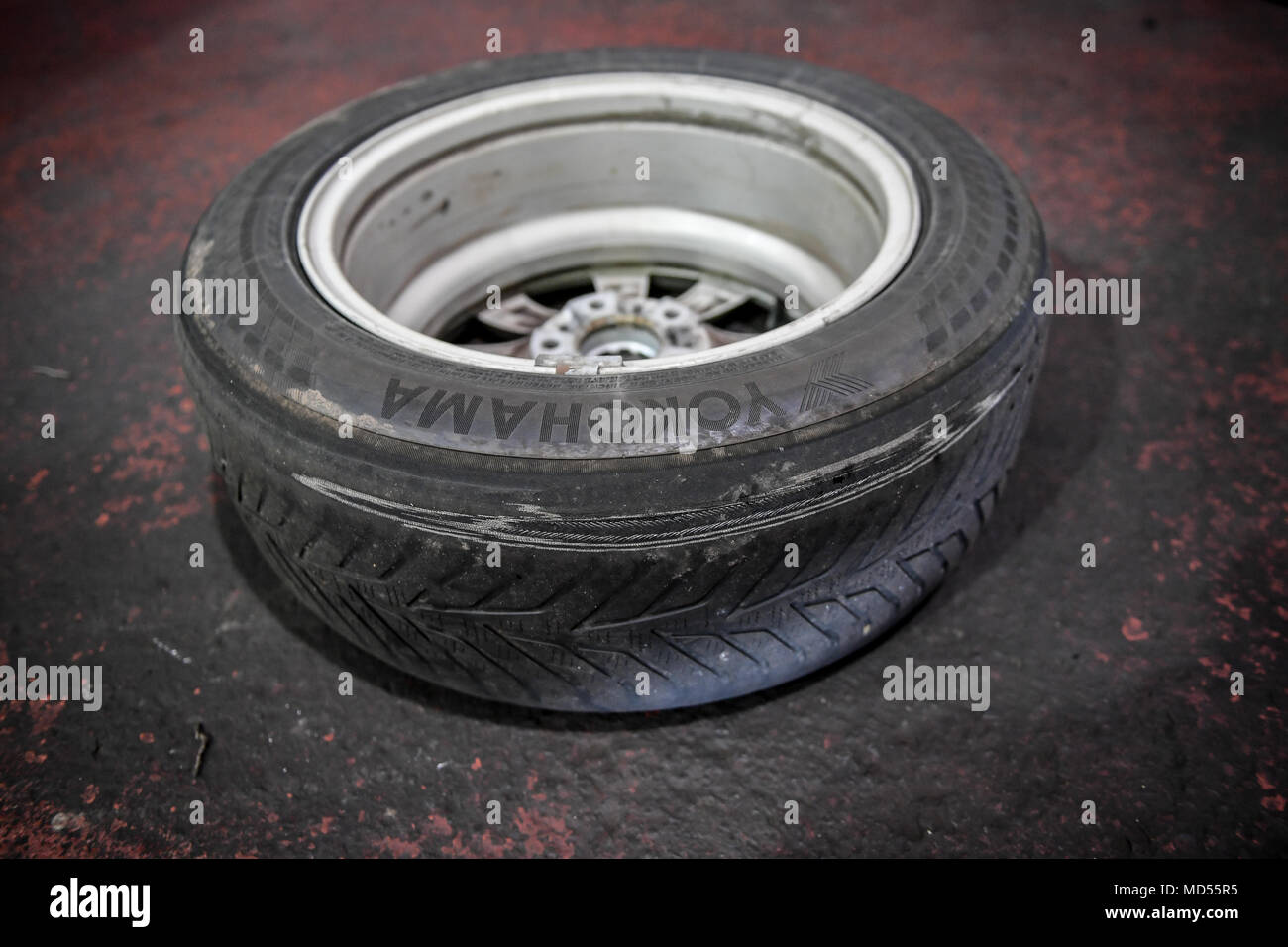 A car tyre on the floor of a garage Stock Photo - Alamy