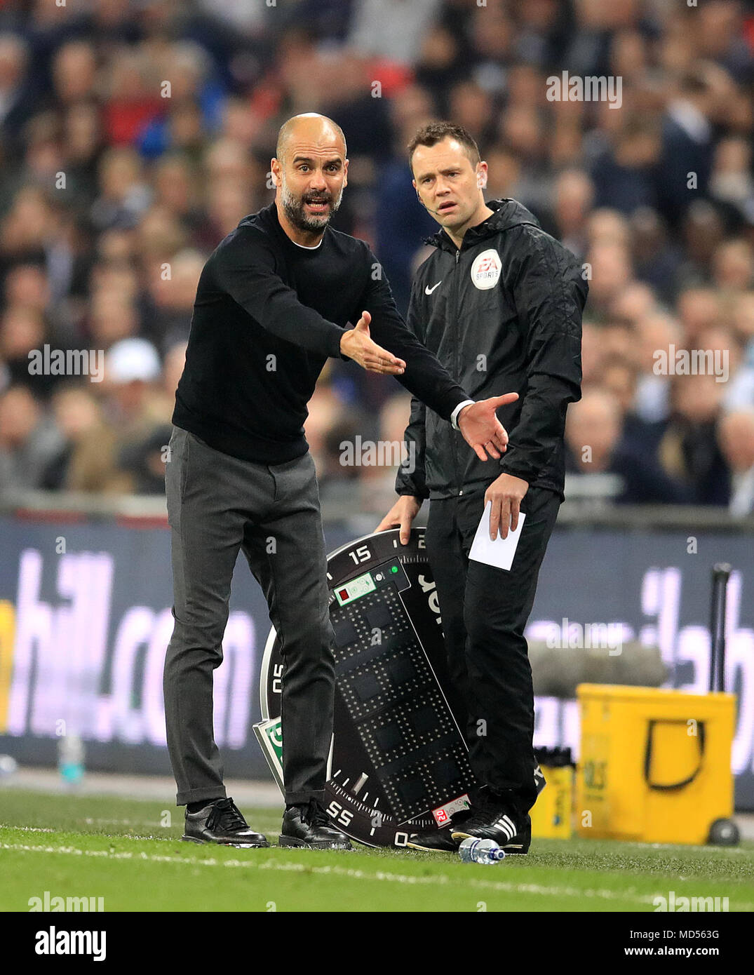 Manchester City manager Pep Guardiola gestures (left) to assistant ...