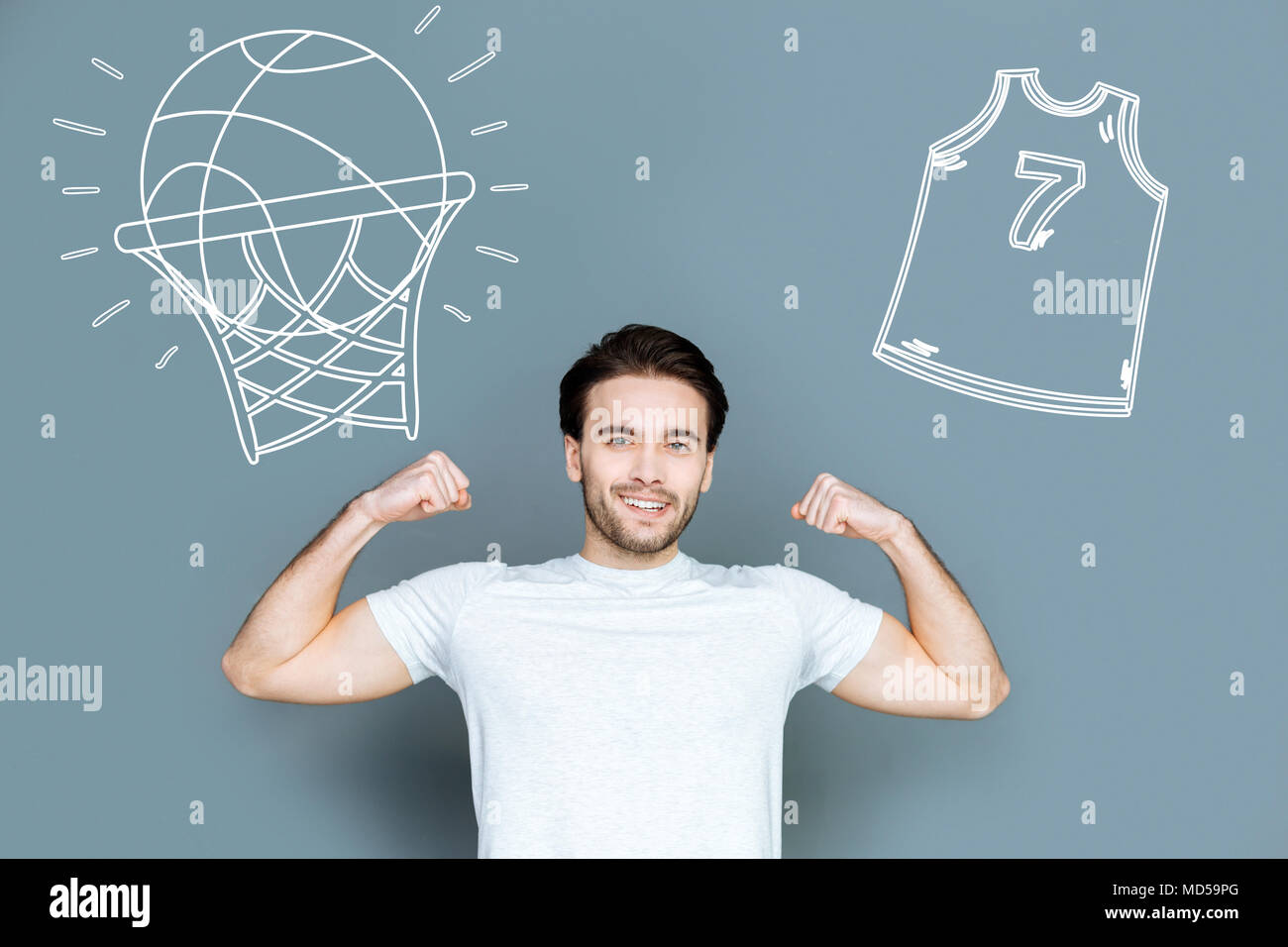 Smiling basketball player looking strong and showing his muscles Stock ...