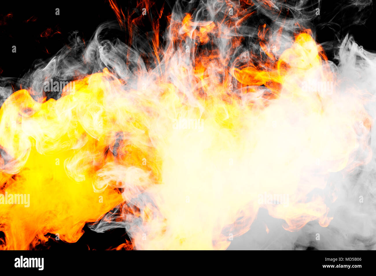 Thick fiary smoke on a black isolated background. Fire flames ...