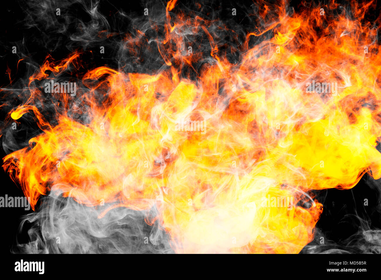 Thick fiary smoke on a black isolated background. Fire flames ...