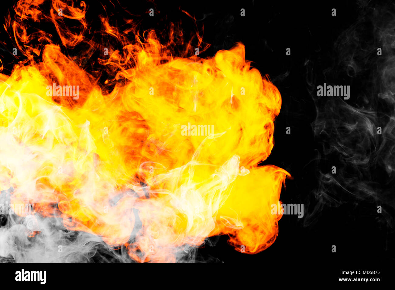 Dense fiery flames smoke on a black isolated background. Background of ...