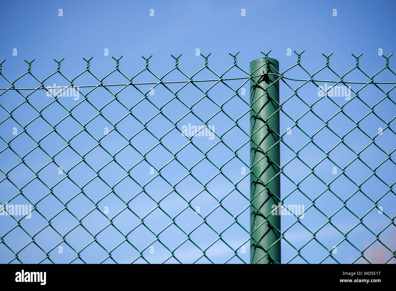 Chain Link Fence with a Blue Sky Background Stock Photo - Alamy