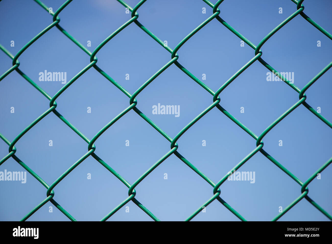 Chain Link Fence with a Blue Sky Background Stock Photo - Alamy