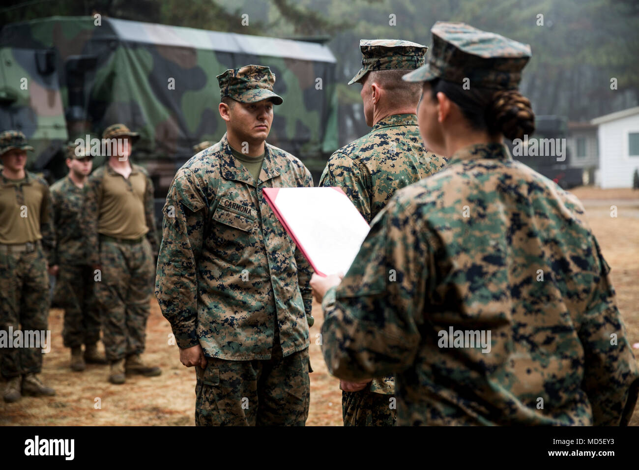 Cpl. Saul Carmona and Col. Craig Doty stand at attention during Carmona ...