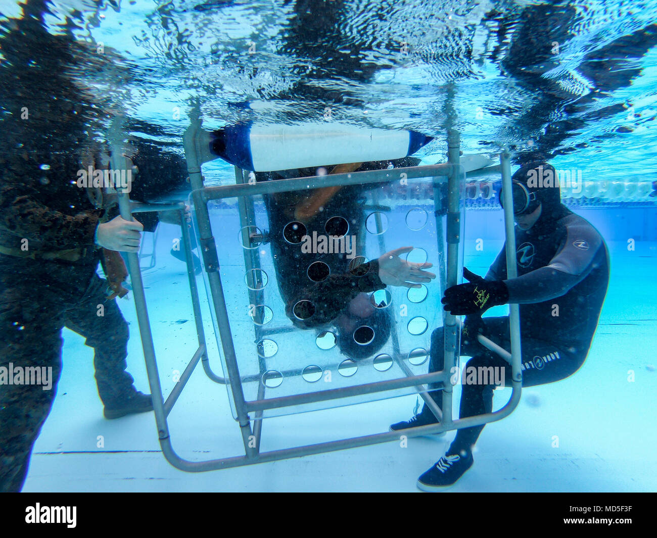 U.S. Marine Lance Cpl. Troy Hill pushes out the window of the shallow ...