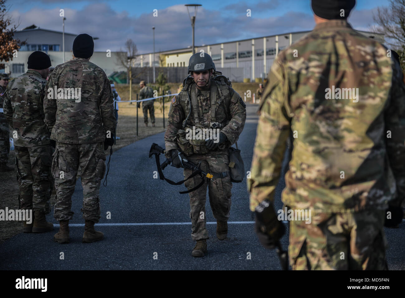 A 173rd Airborne Brigade paratrooper crosses the finish line after a 12 ...