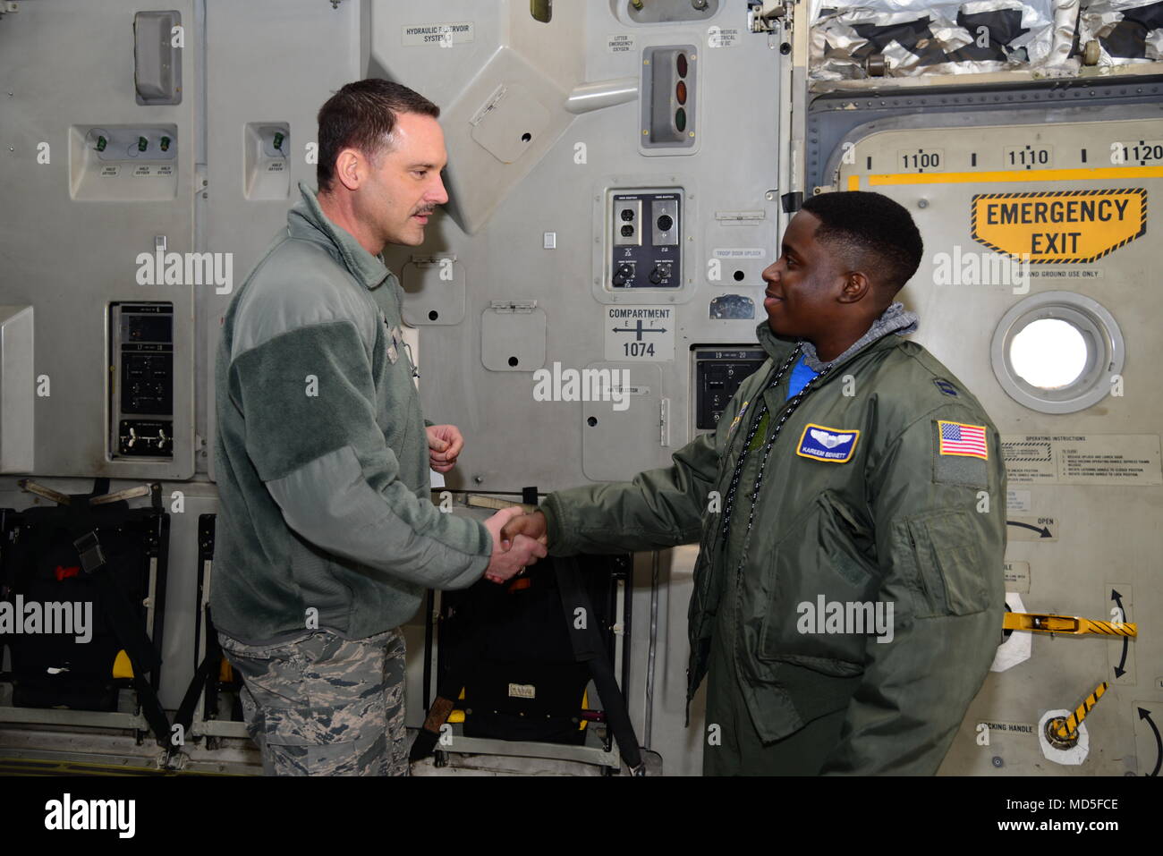 Col. Ethan Griffin, 436th Airlift Wing commander, presents a coin to ...