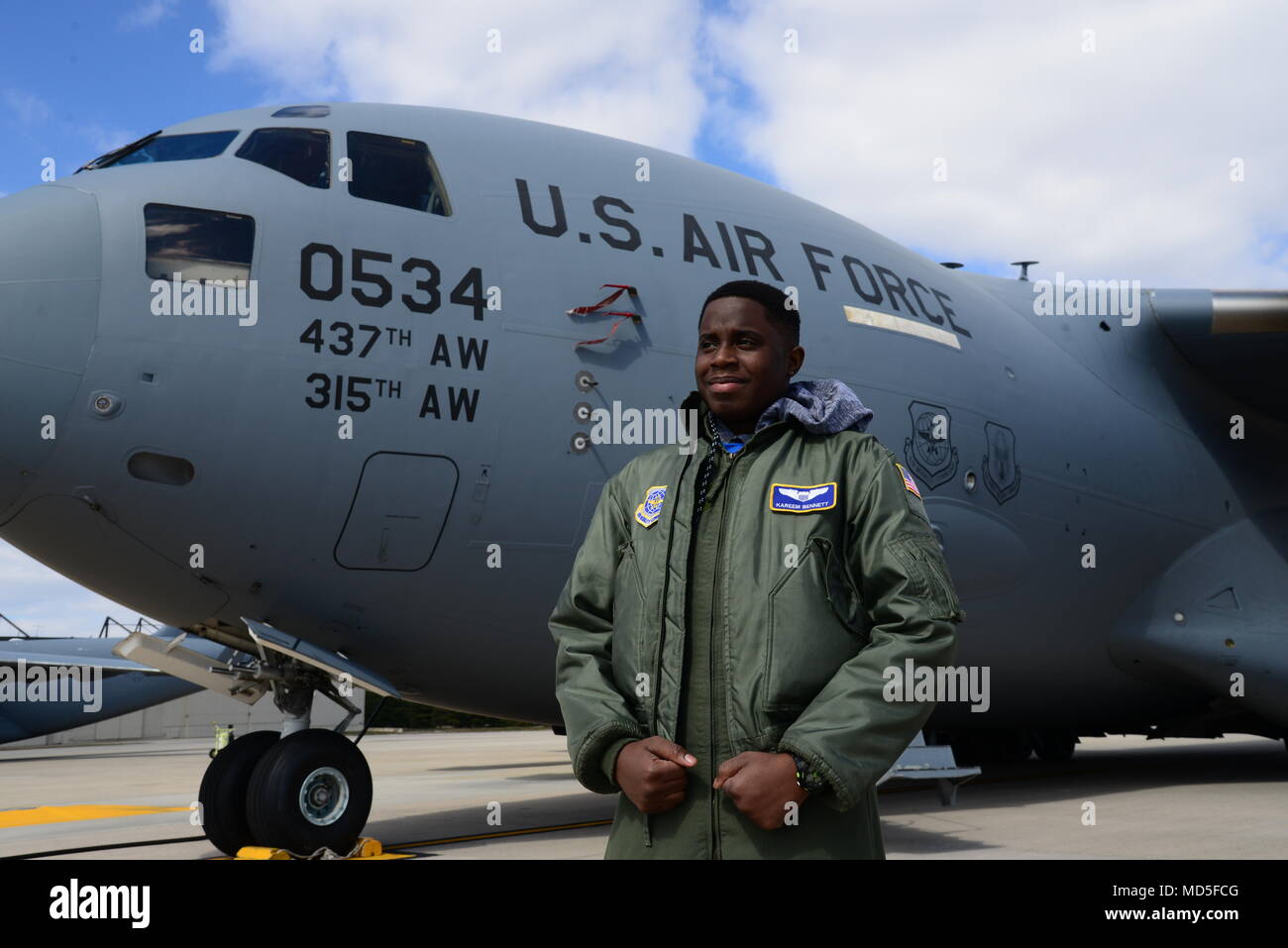 Kareem Bennett, 3rd Airlift Squadron honorary pilot for a day, stands ...