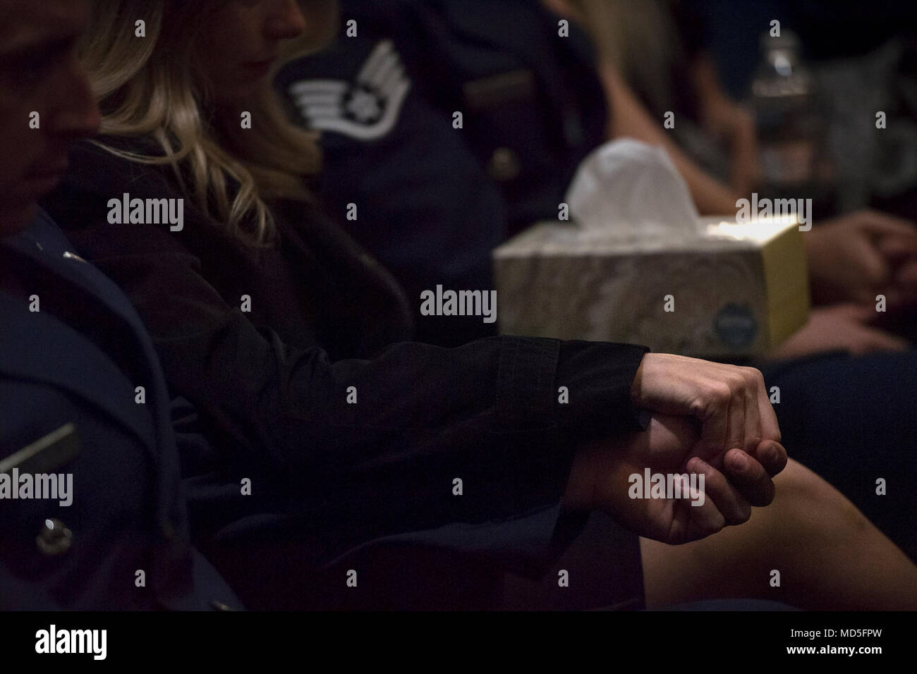 Guests hold hands during a memorial service in honor of Capt. Mark ...