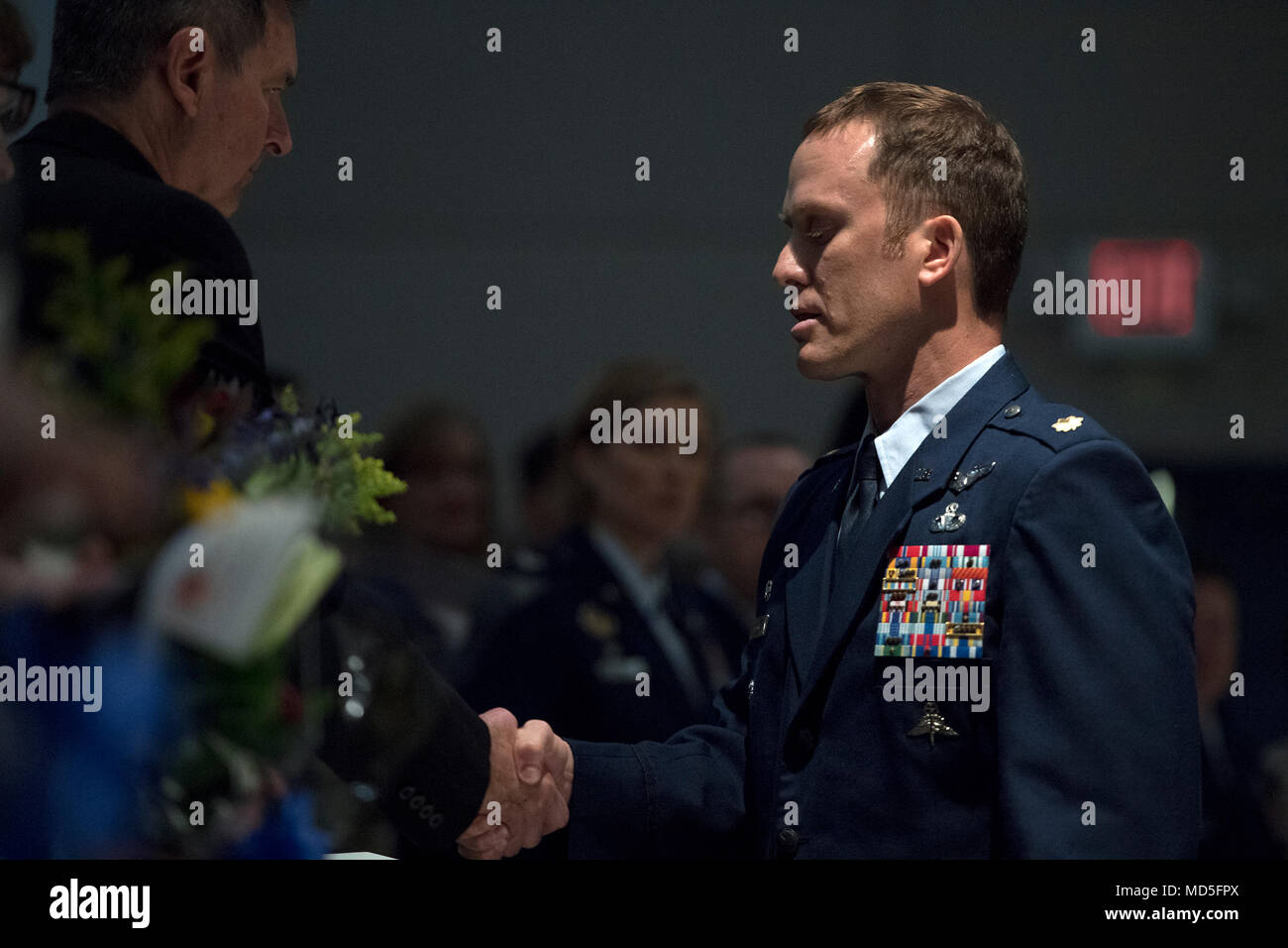 Maj. Jason Egger, 38th Rescue Squadron commander, shakes hands with Ron ...