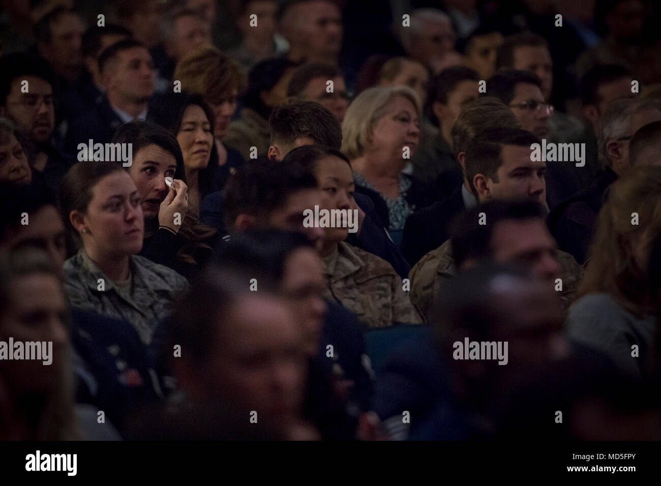 Guests watch a memorial service in honor of Capt. Mark Weber, March 21 ...
