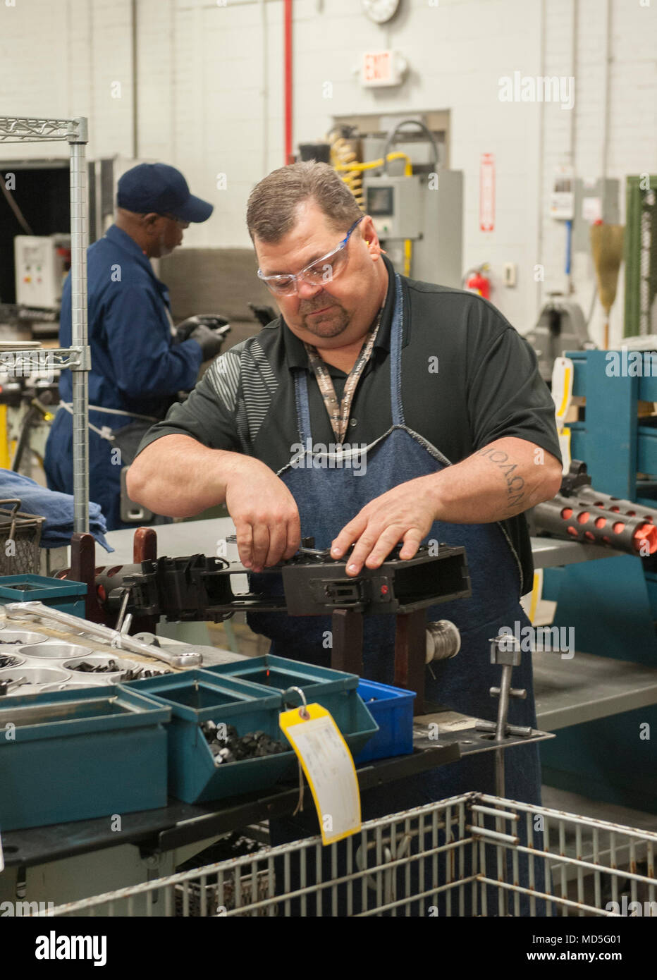 Christopher Cotten installs the retracting slide on a M2A1 machine gun ...