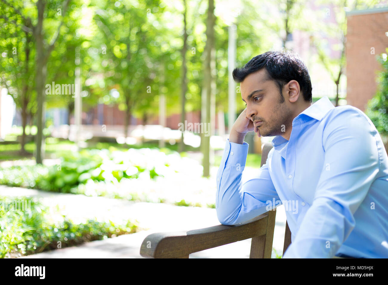 Closeup portrait, stressed young business man, resting face on fist ...