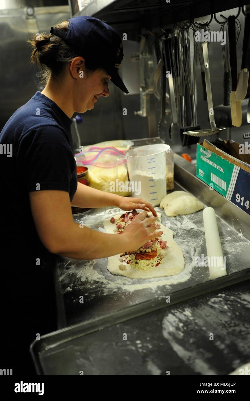A Culinary Specialist aboard the Coast Guard Cutter Mackinaw prepares ...