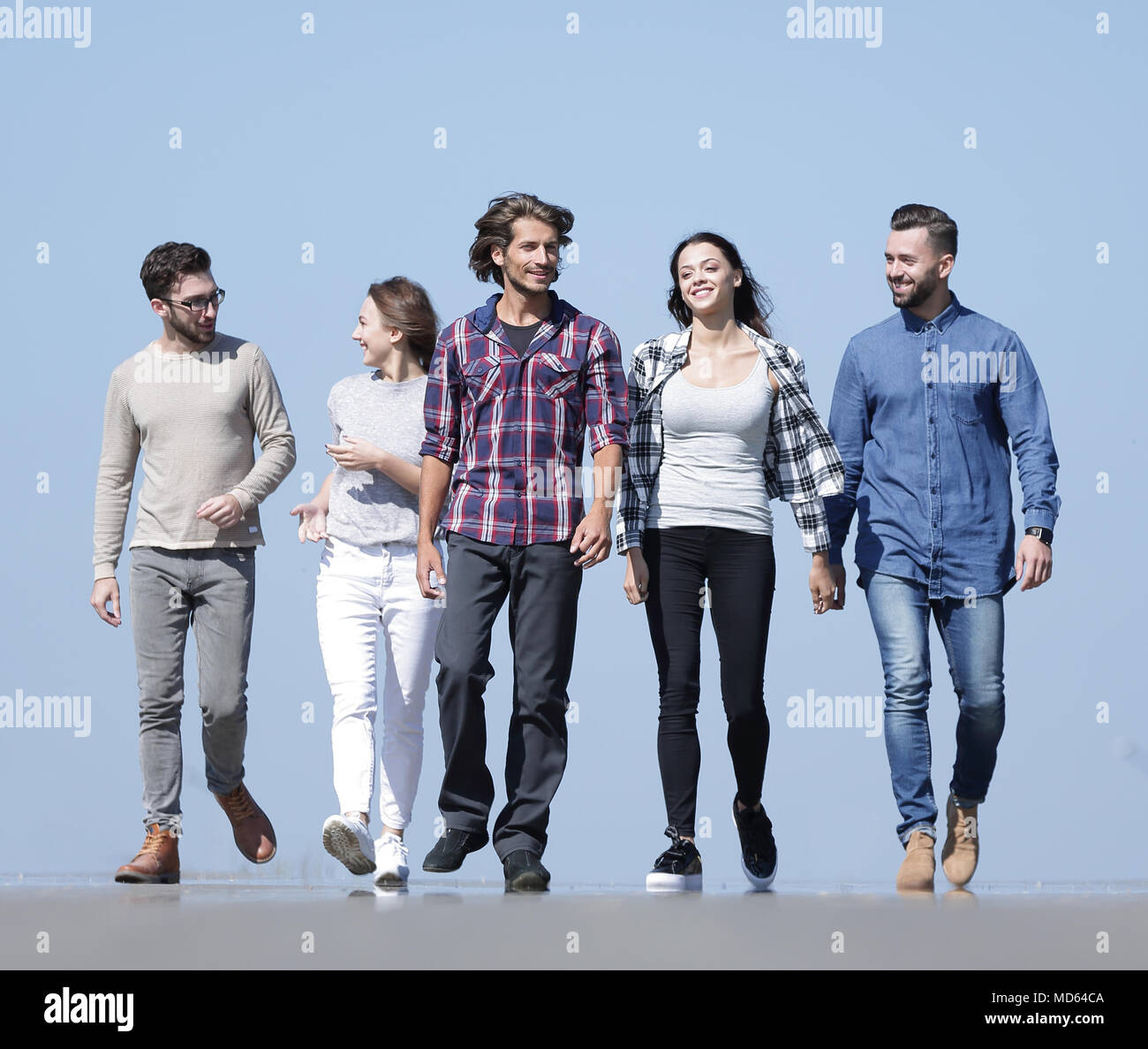 team of young people walking along the road.outdoors Stock Photo - Alamy