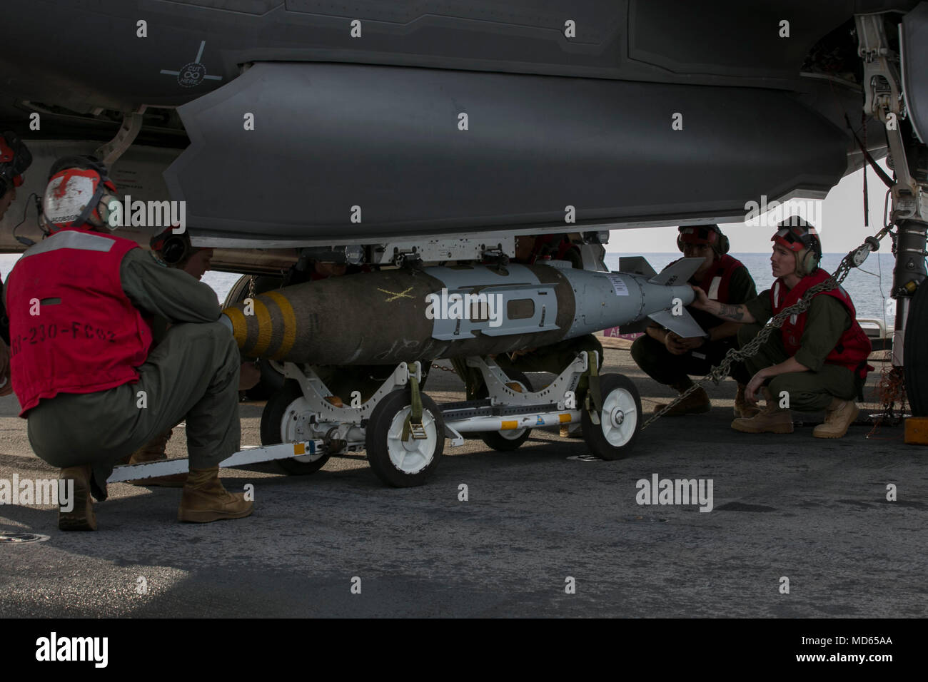 Marines with Marine Fighter Attack Squadron 121 mount a 1,000 pound ...