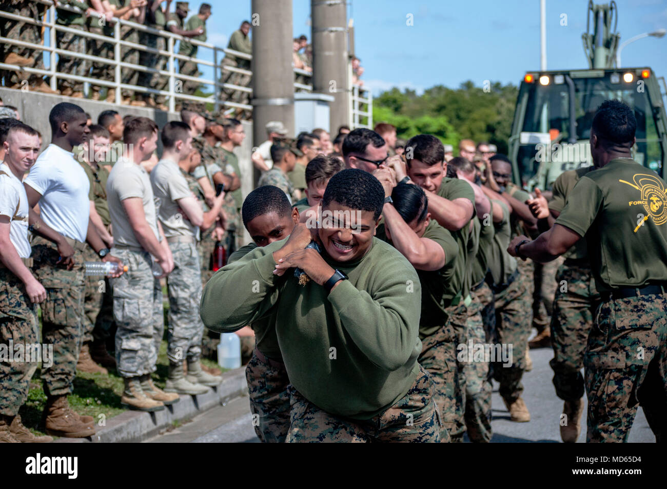 Marine Cpl. Lorenzo Harper assists in the vehicle pull during the Saint ...