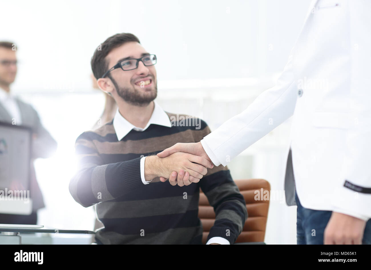 handshake between colleagues in the workplace Stock Photo - Alamy