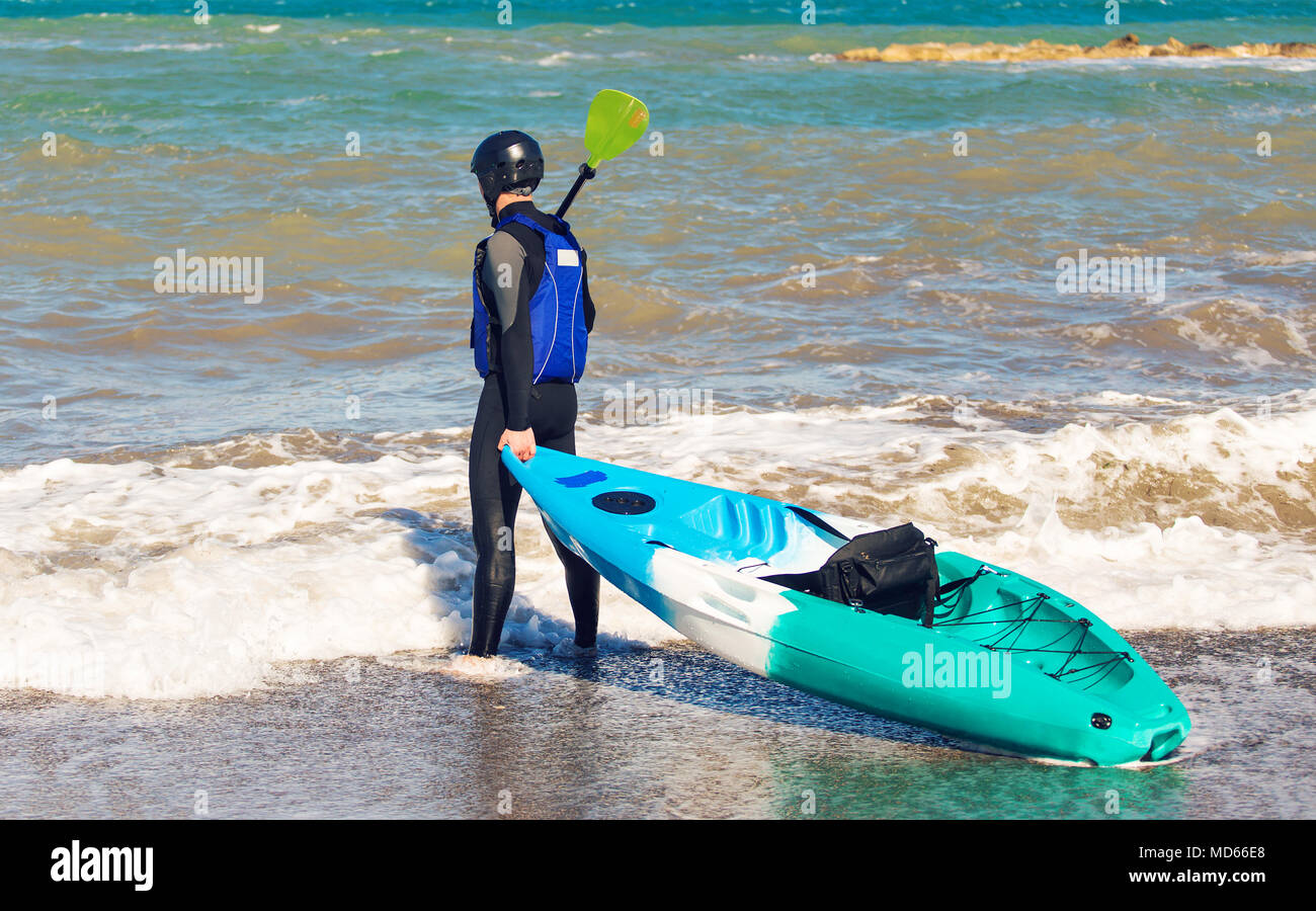 man carrying kayak at sea beach Stock Photo - Alamy