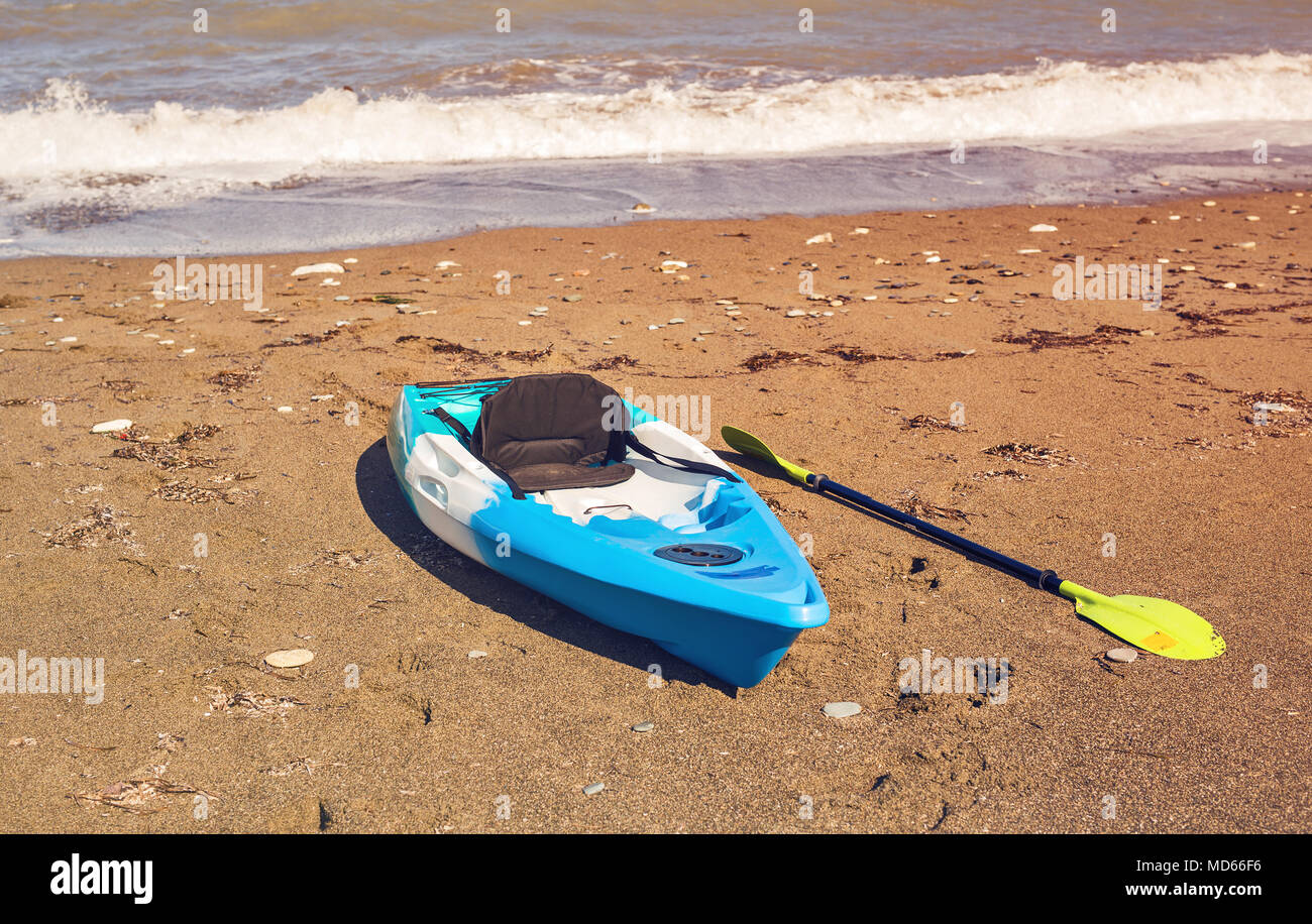 Blue kayak lying on the sandy beach Stock Photo - Alamy