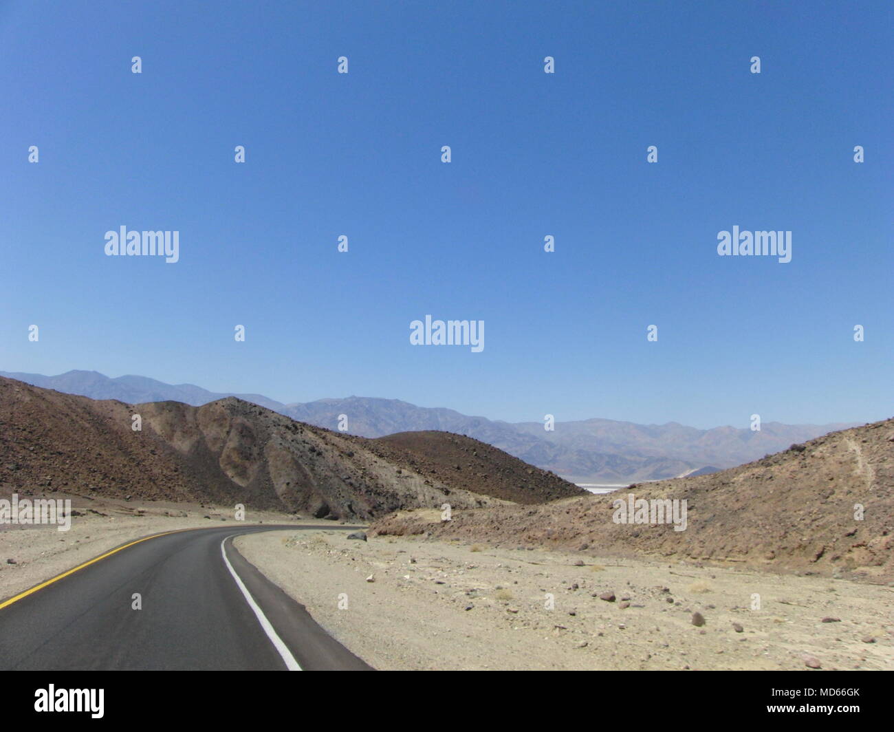 Desert road. Abrupt turn. Mountain landscape. Blue sky Stock Photo - Alamy