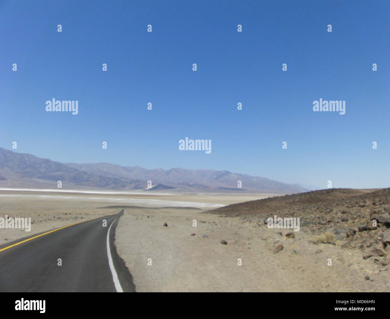 Desert road. Abrupt turn. Mountain landscape. Blue sky Stock Photo - Alamy