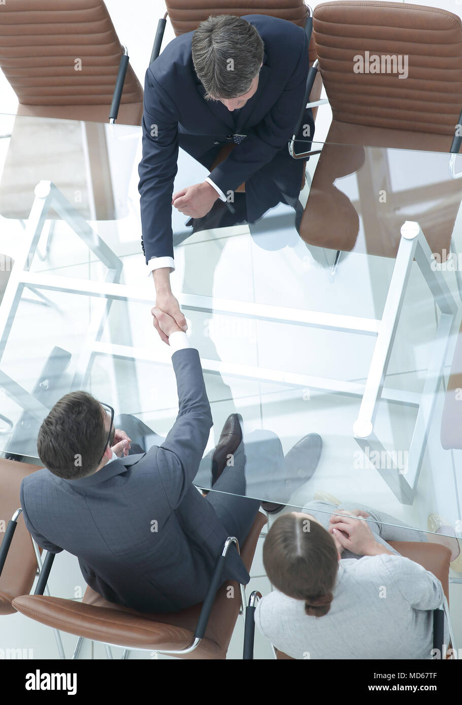 Handshake across the table. Meeting around a boardroom table Stock ...