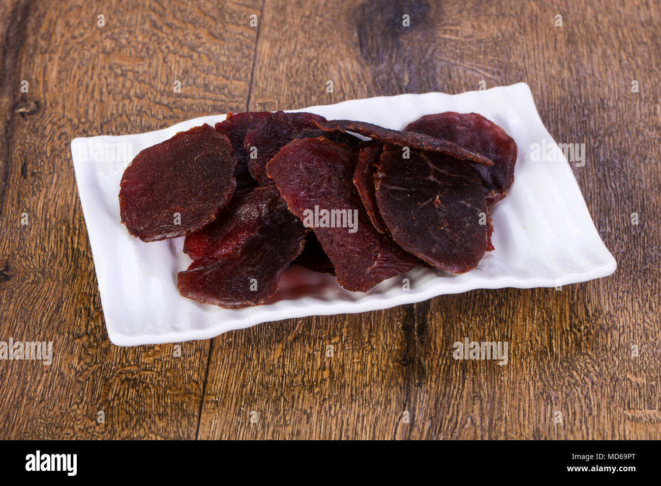 Dry beef meat over wooden Stock Photo - Alamy