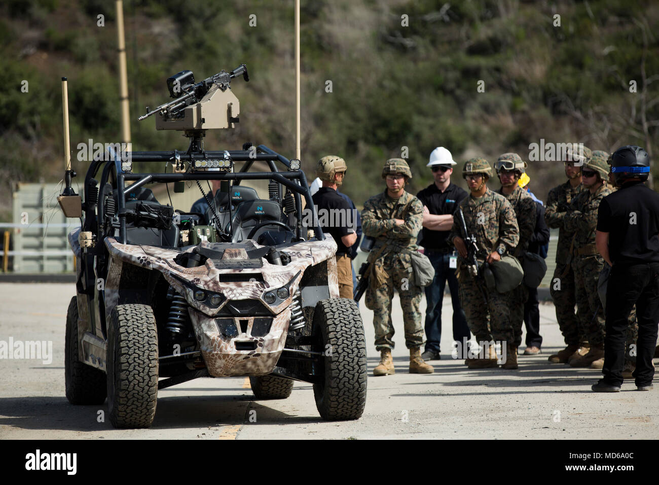 U.S. Marines gather around a light tactical all terrain vehicle (LTATV ...