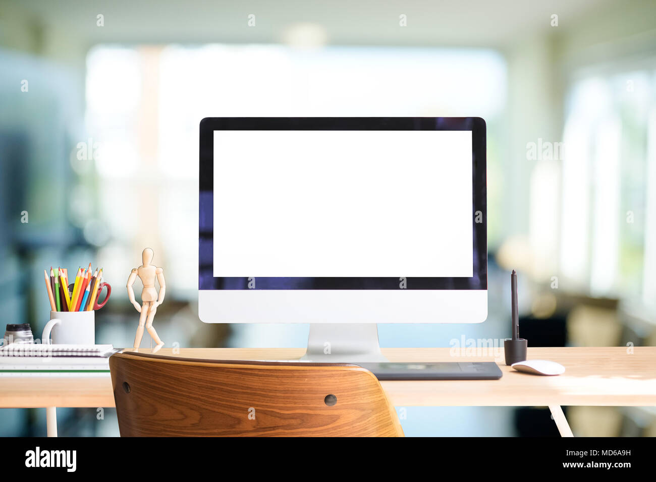 Creative workplace empty white screen computer with tablet digital pen ...