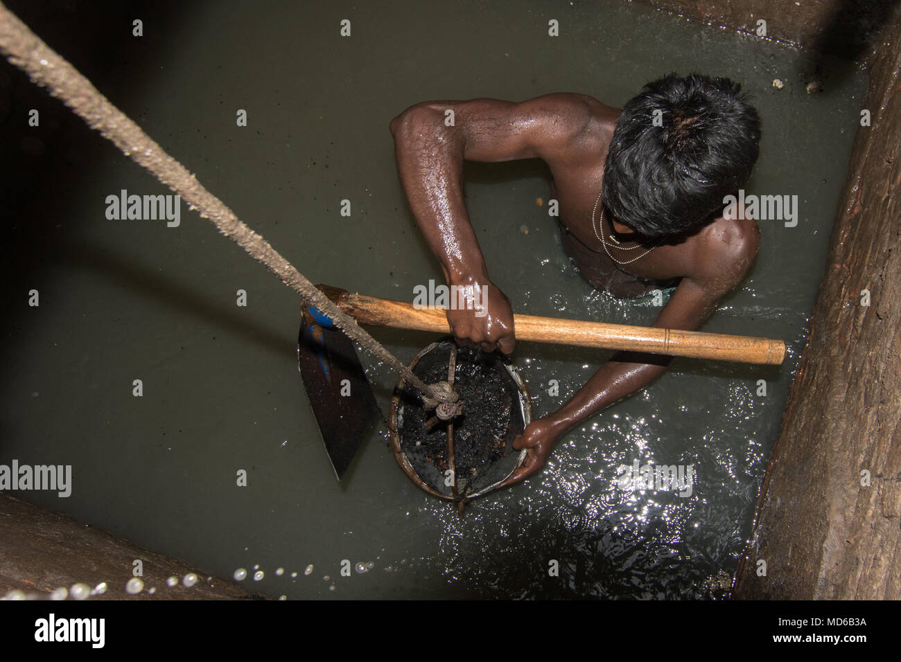 Worst job in the world, Diving down into a hole of sludge with his bare ...