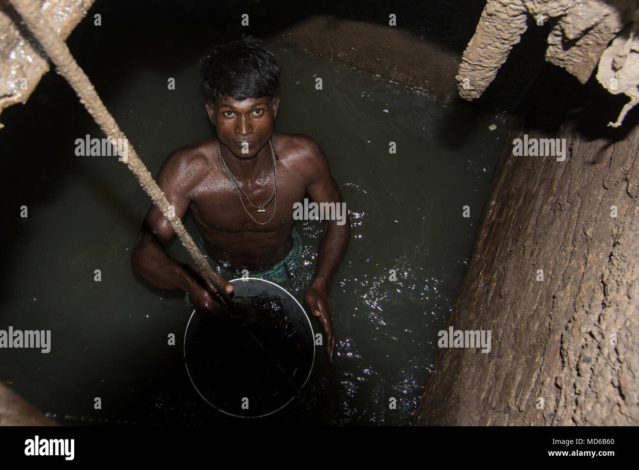 Worst job in the world, Diving down into a hole of sludge with his bare ...