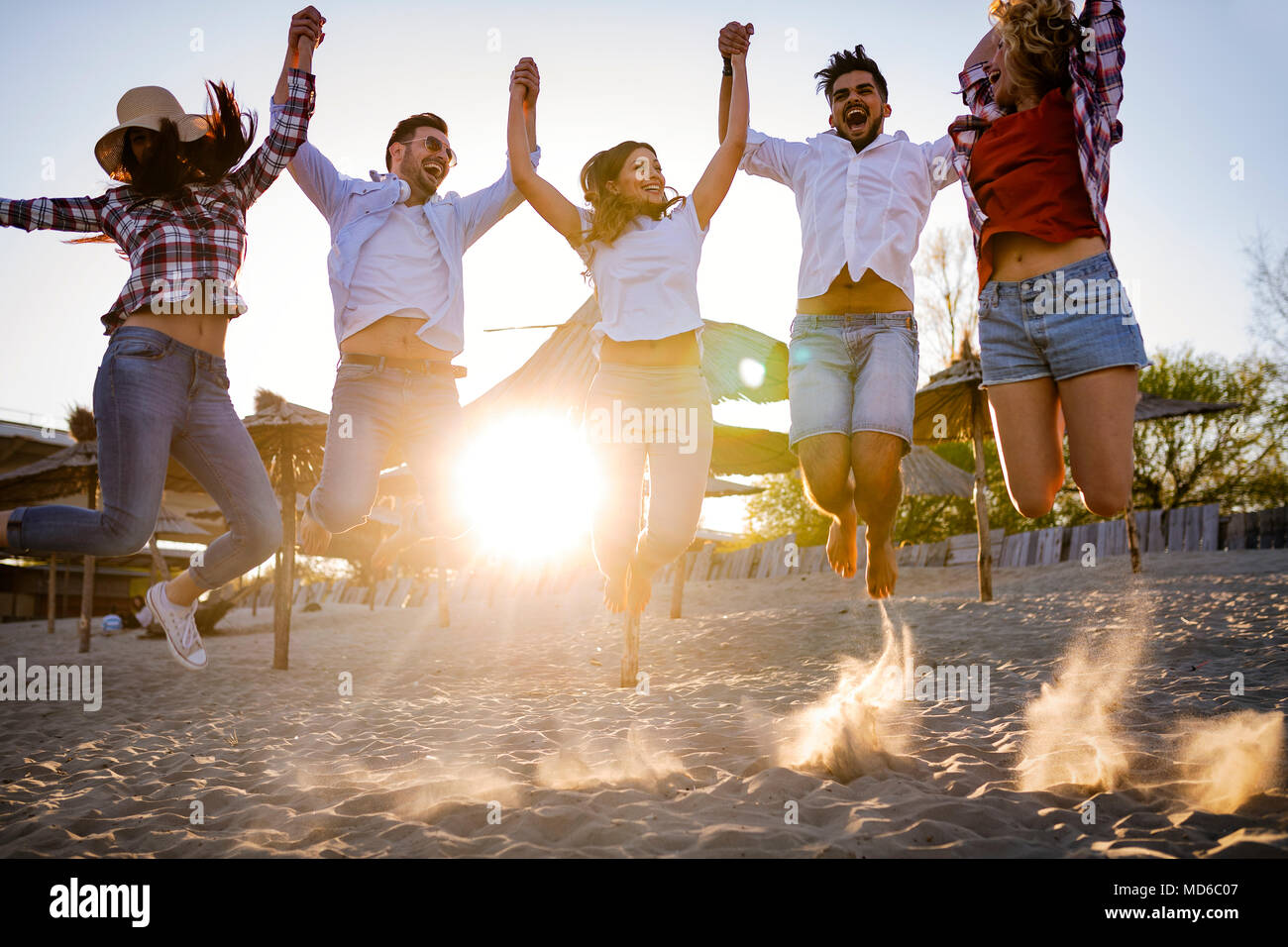 Group of happy young people enjoying summer vacation Stock Photo - Alamy