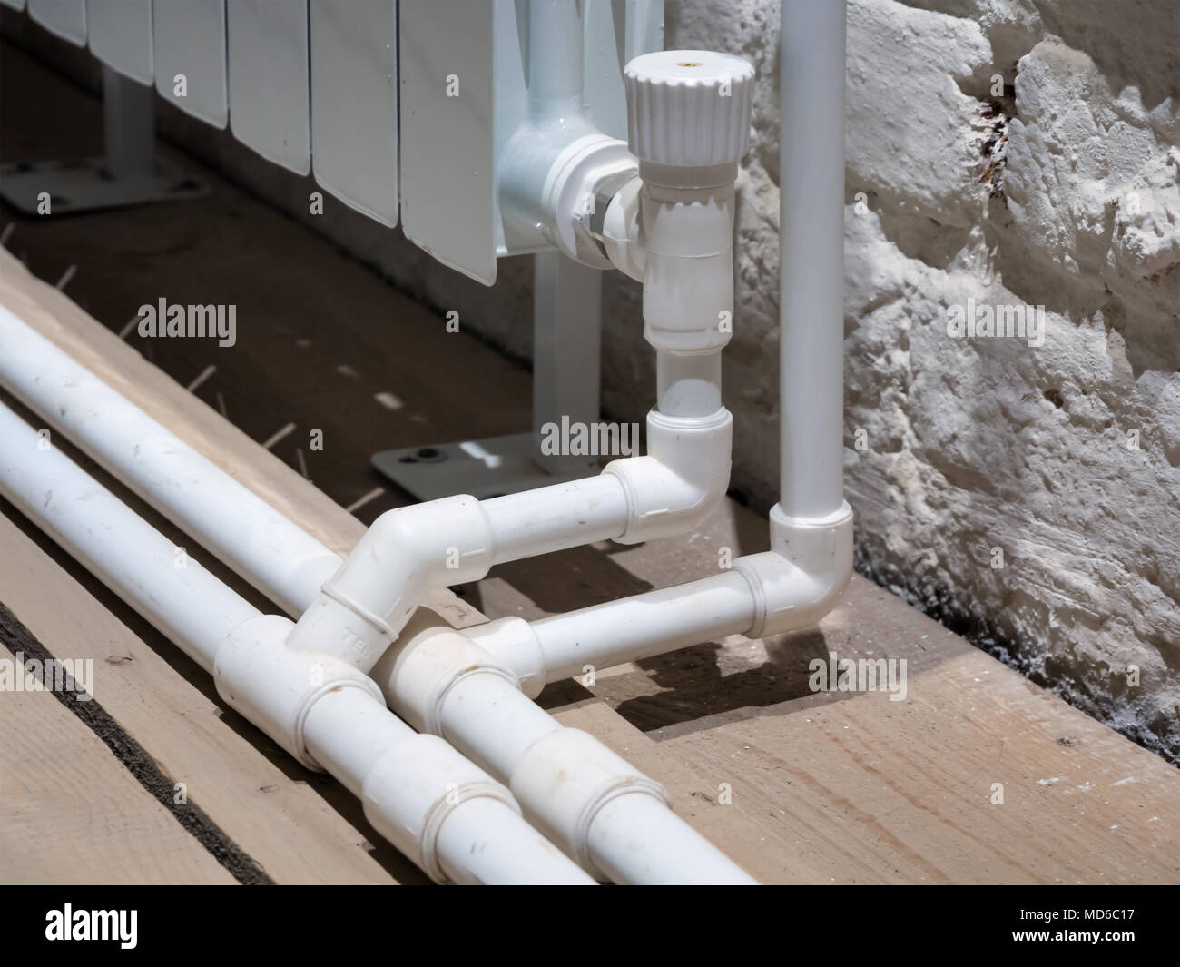 Connecting the bimetal radiator to the heating system Stock Photo - Alamy