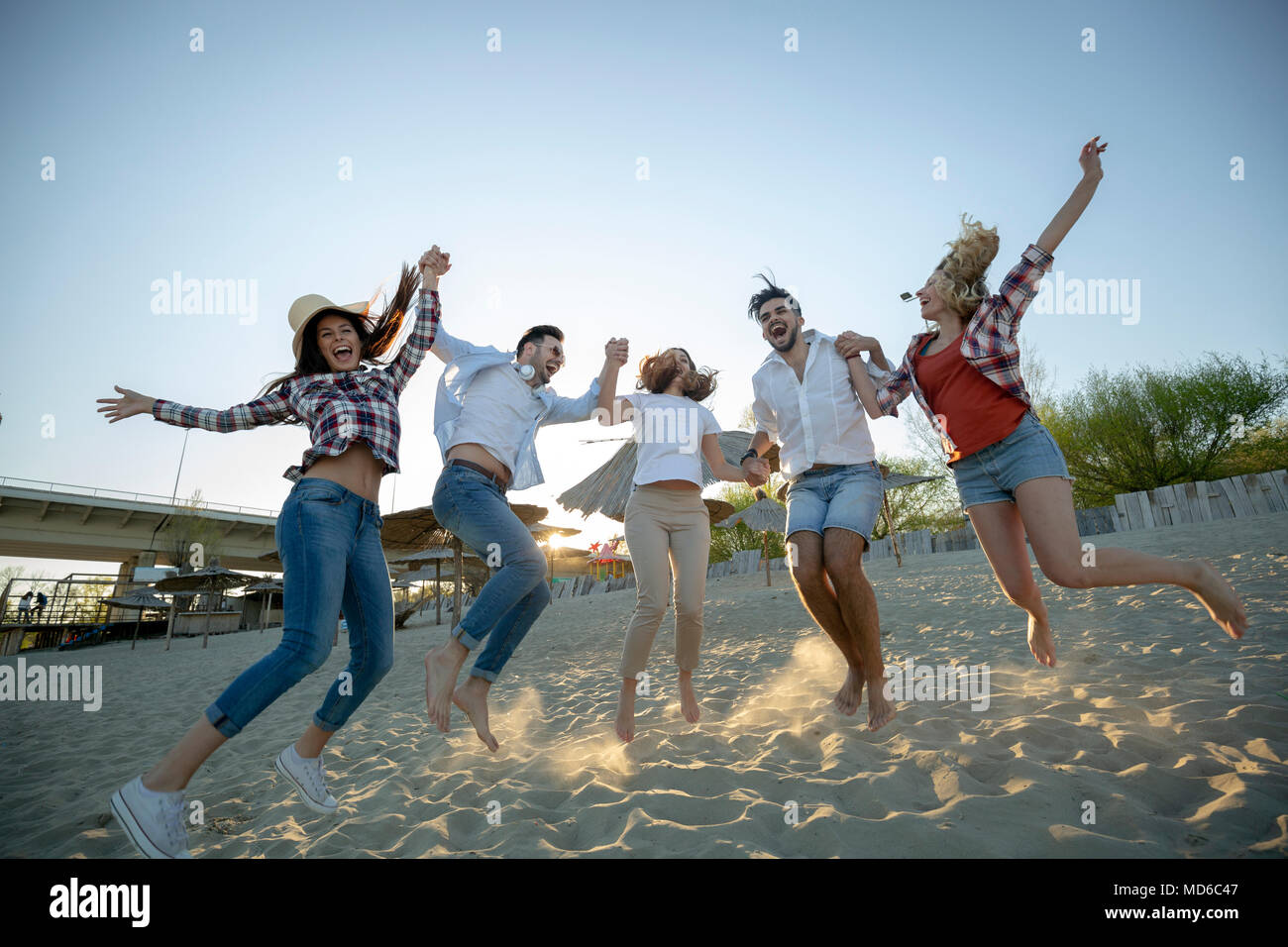 Happy group of young people having fun at beach Stock Photo - Alamy