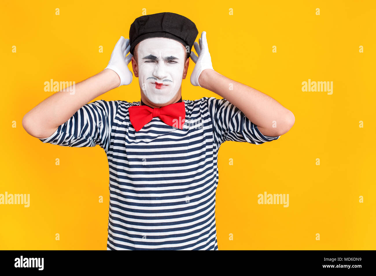Mime man closed ears his hands. Have a unwell look. Emotions and ...