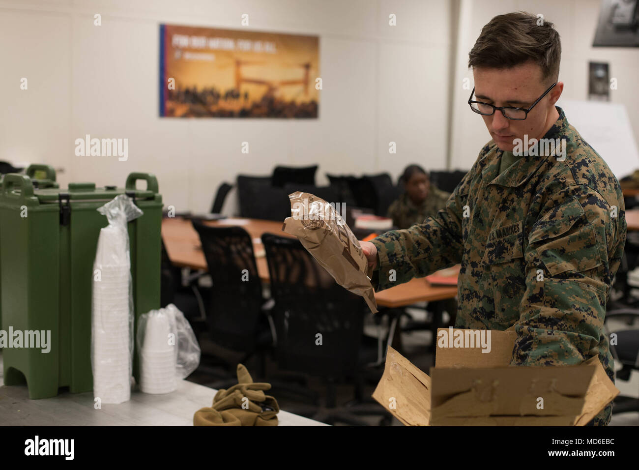 A U.S. Marine receives a Meal-Ready-To-Eat for lunch during the ...