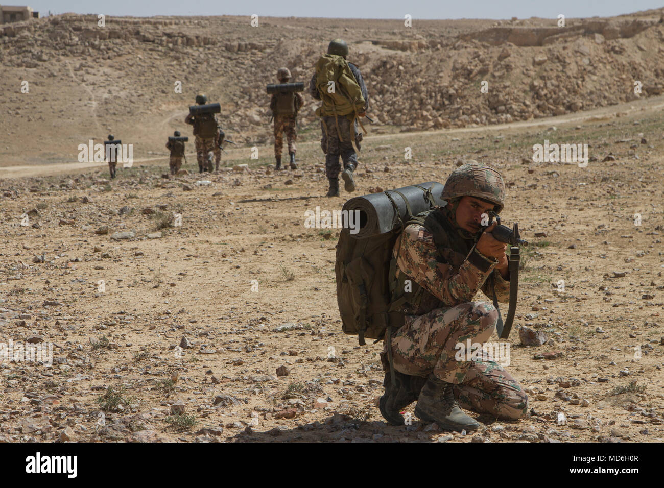 Jordanian service members conduct a simulated patrol as part of the ...