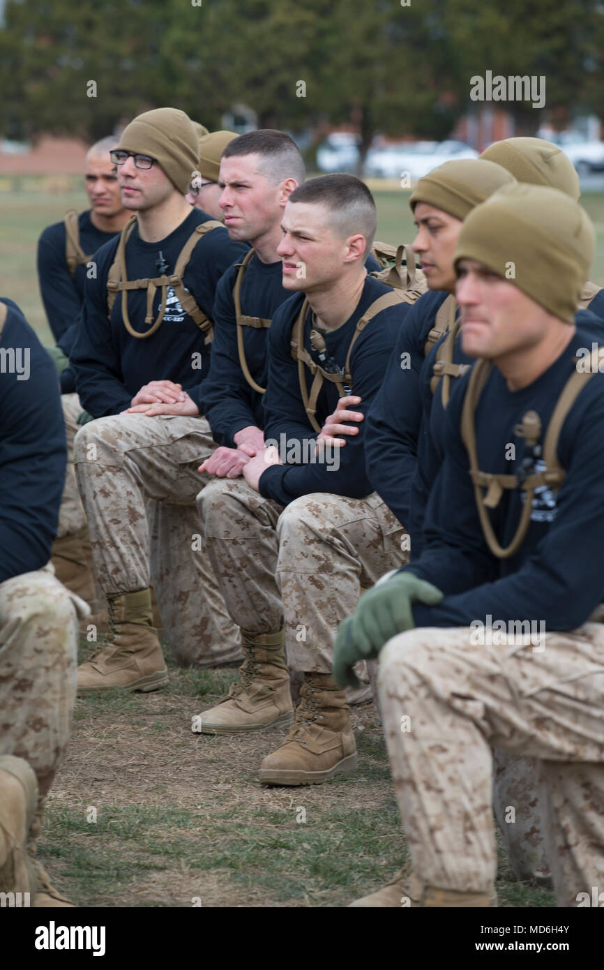 U.S. Marine officer candidates listen to instructions during a field ...