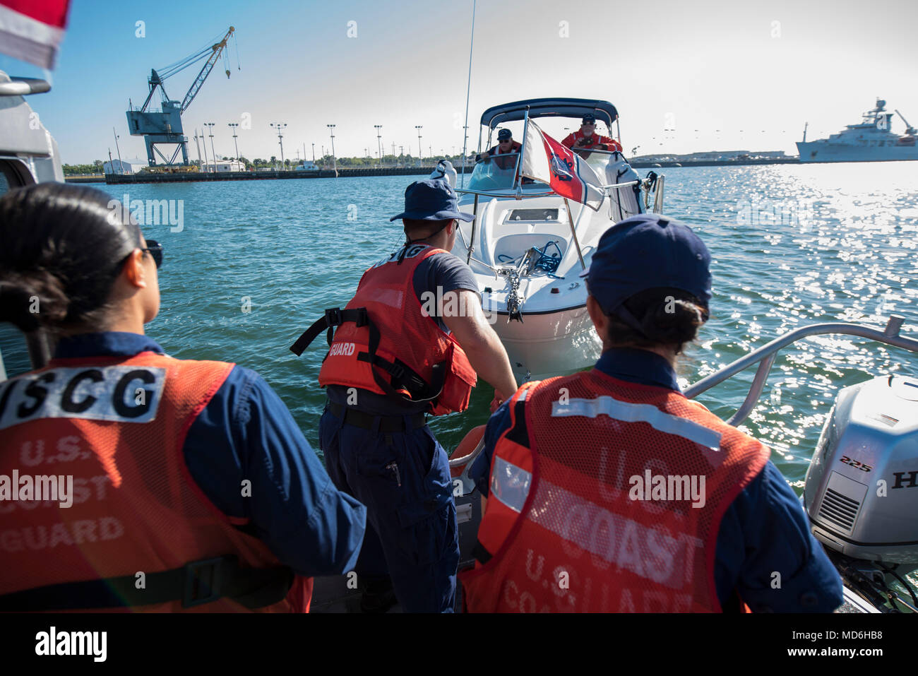 Fireman Trenton Duck hooks a towline to a Coast Guard Auxilary boat ...