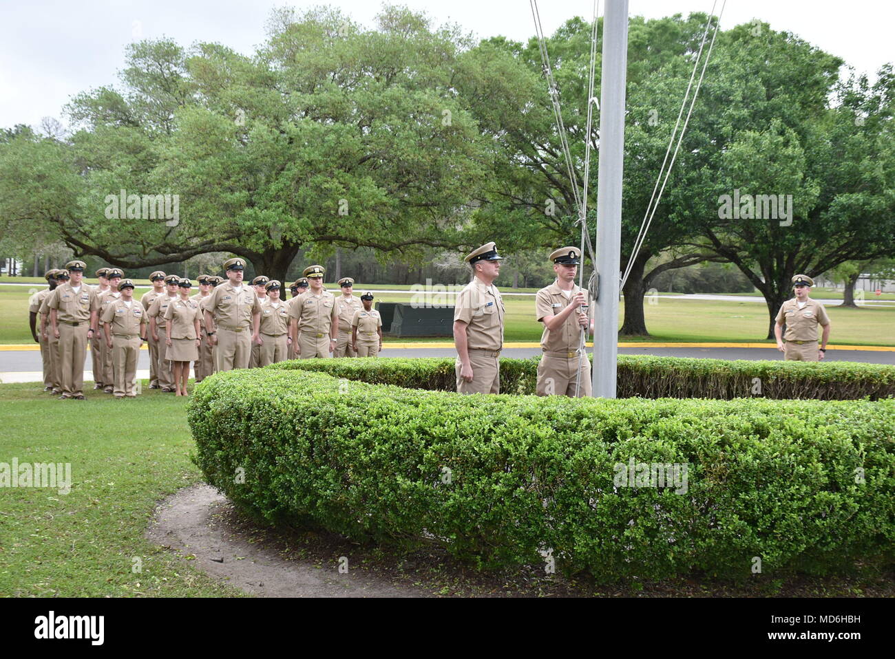 AGC Jason Archibald (left) and AGC Chad Collier (right) raise the flag ...