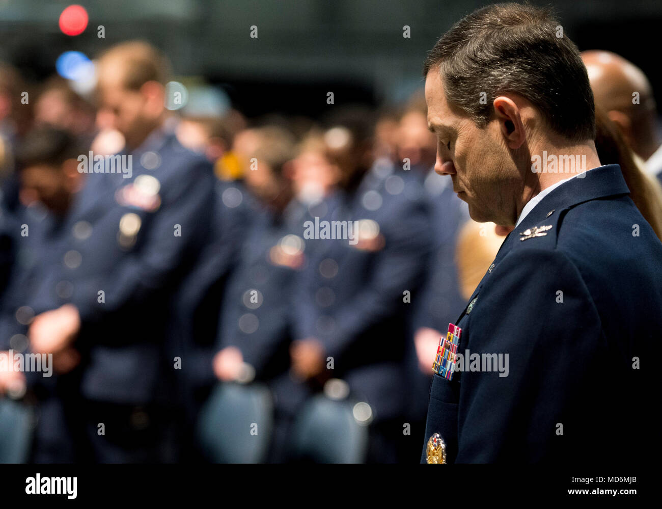 Col. Bradley McDonald, 88th Air Base Wing commander, bows his head ...