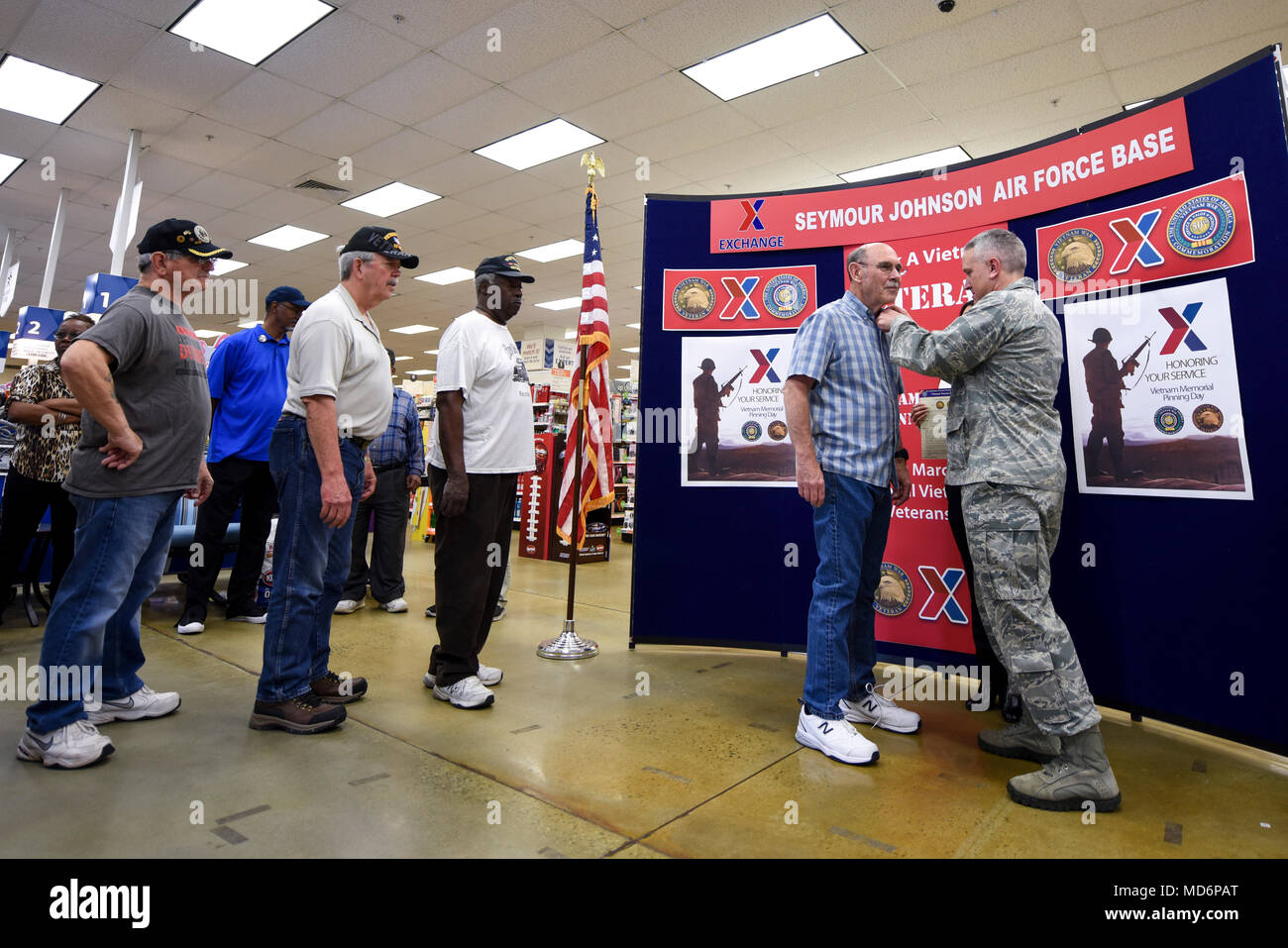 Col. Jason Knight (right), 4th Mission Support Group commander, places ...